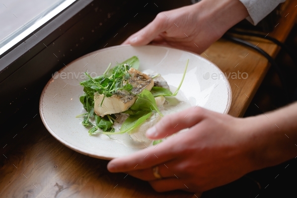 sea fish pike perch with baked potatoes and porcini mushroom sauce ...