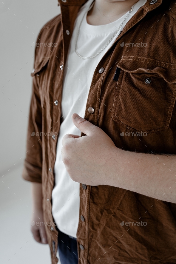human body details, full man holding mustard shirt with his hands Stock ...