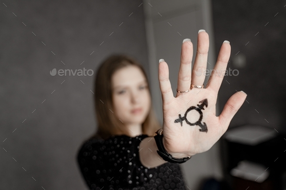The girl shows on her hand the combined symbol of androgyne and ...