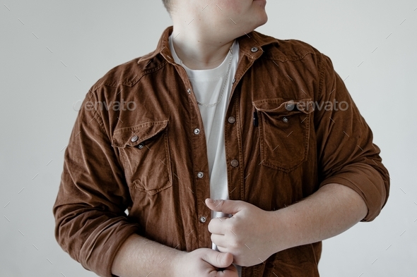 human body details, full man holding mustard shirt with his hands Stock ...