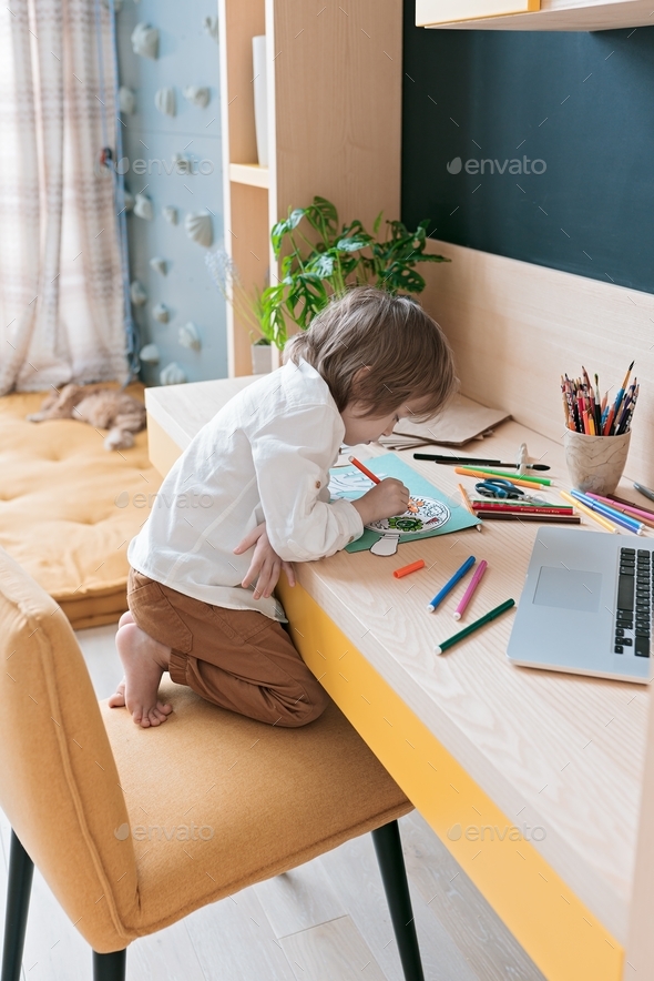 Distance learning at home, online class. Preschool boy learns to draw ...