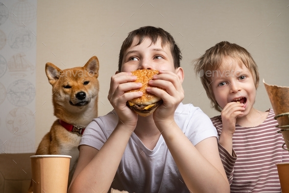 Three friends eating fast food. Stock Photo by egrigorovich | PhotoDune