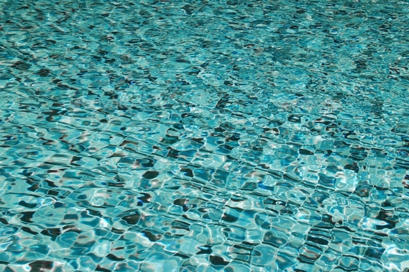 Ripple effect in the swimming pool. Blue water texture for background ...