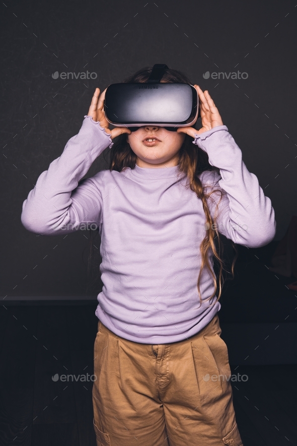 teenage girl playing virtual reality in vr glasses, new normal ...