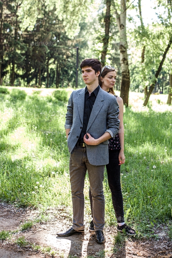 beautiful young girl hugs a guy and looks over his shoulder Stock Photo ...