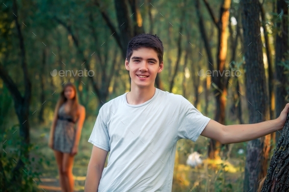 Portrait of a handsome guy in the woods near the tree Stock Photo by ...