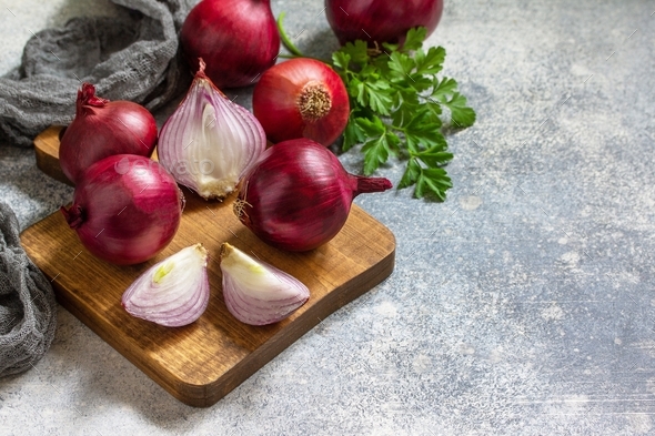 Purple Onions. Fresh whole purple onions and one sliced onion on a ...