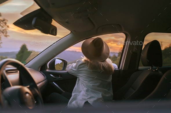 Student girl looking outside the window of the car Stock Photo by lenade