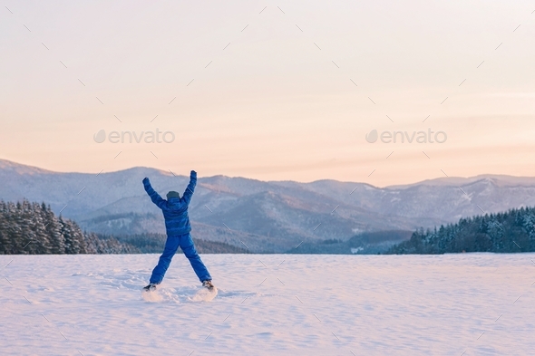 Outdoor winter activities for kids. Boy running in snowy weather in ...