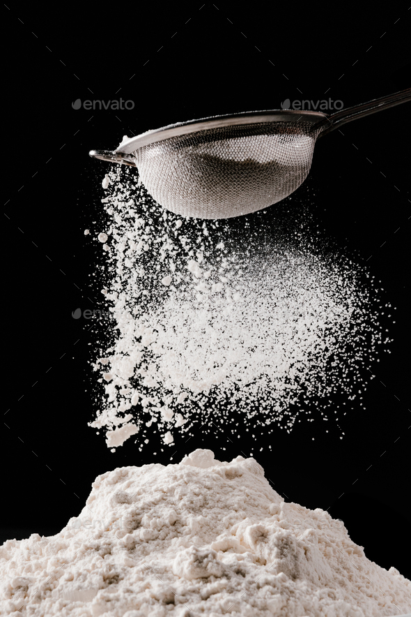 flour falling from sieve on pile isolated on black Stock Photo by ...