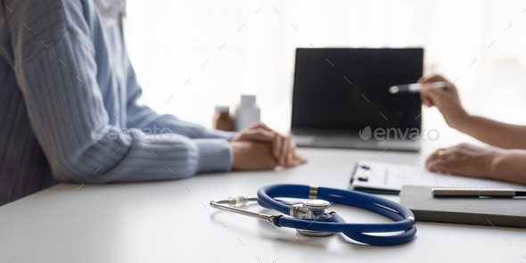medical consultation - doctor talking to patient in clinic office on ...