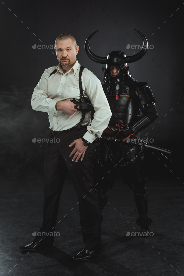 man with gun and samurai behind him on black Stock Photo by ...