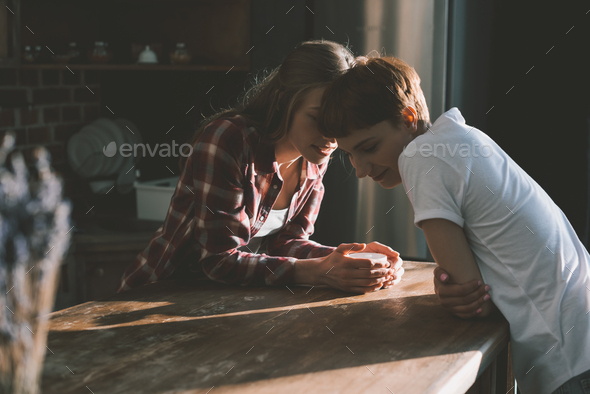 Young Lesbian Couple Spending Time Together On Kitchen In Morning Stock