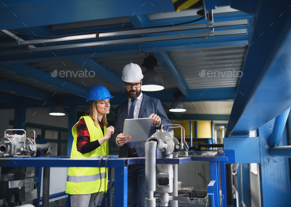 Engineering manager and mechanic worker doing routine check up in ...