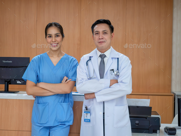 At hospital information counter doctor speaking to nurse and stand ...