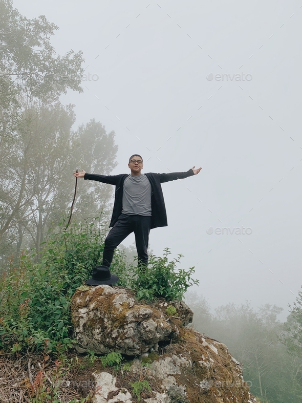Boy in the middle of the forest with fog Stock Photo by edgar_rood