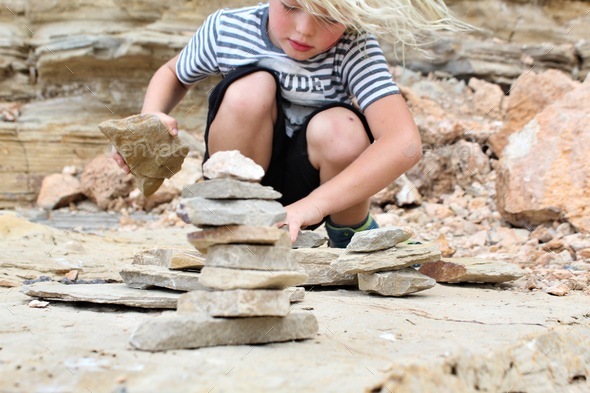 Boy making rock towers Stock Photo by pernilla11 | PhotoDune