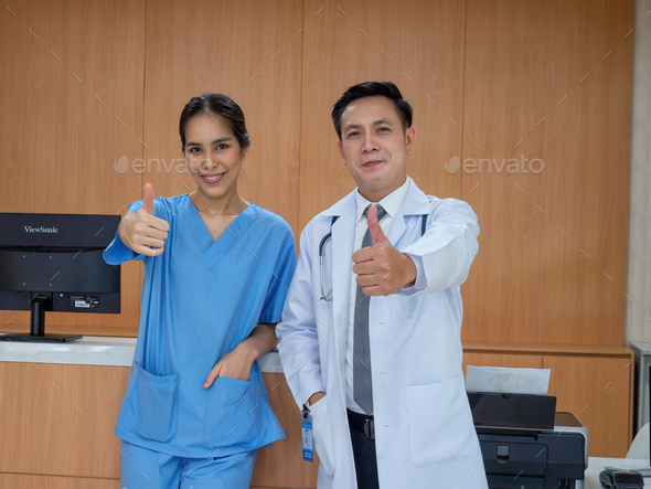 At hospital information counter doctor speaking to nurse and stand ...