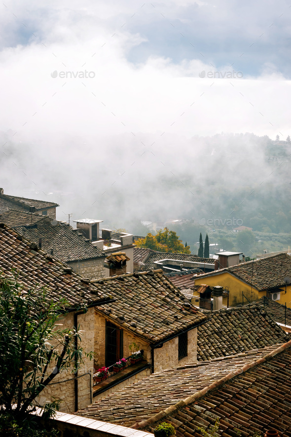Old Italian stone house with tiled roof and flowers overlooking the ...