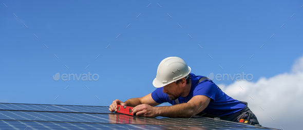 Man worker installing solar photovoltaic panels on roof, alternative ...