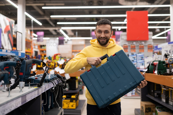 Satisfied buyer of a power tool store holding a case with a smile Stock ...