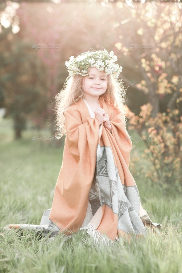 Smiling baby girl 4-5 year old posing outdoors. Looking at camera ...