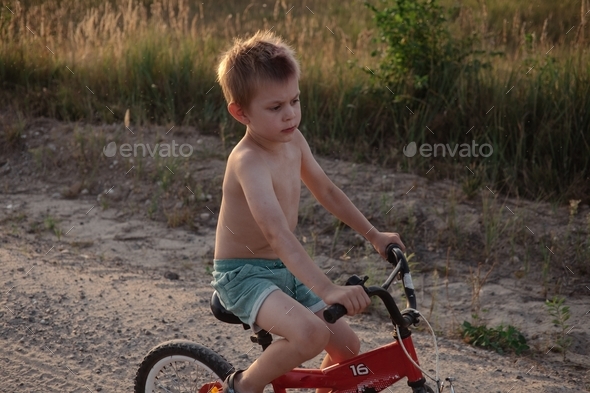 Little boy riding a bike Stock Photo by lamapacas | PhotoDune