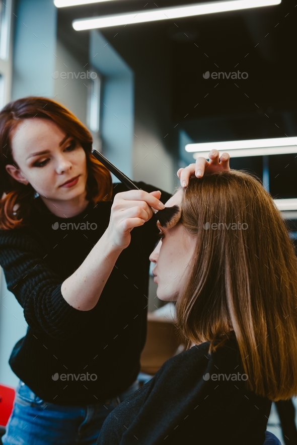 The makeup artist does makeup. Professional makeup for a photo session ...