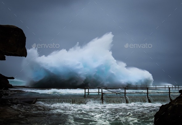 Huge waves crash on the edge of an ocean pool during a stormy day Stock ...