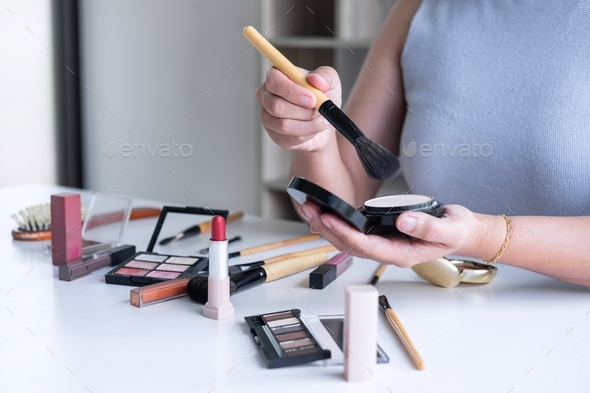 Elegant female Beauty blogger showing testing beauty cosmetic using ...