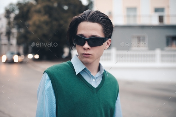 Serious teenage boy 19-20 year old wear sunglasses and trendy casual ...