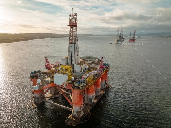 Oil Drilling and Decommissioning Rigs at Sunset Stock Photo by Stock87