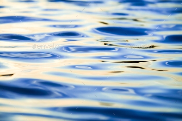 The texture of smooth water with sunlight across the surface Stock ...