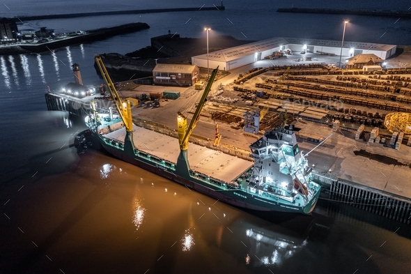 Cargo Ship at a Port at Night Offloading Cargo and Goods Stock Photo by ...
