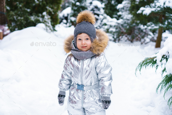 In winter, child plays in snow. Winter scene with child. Happy ...