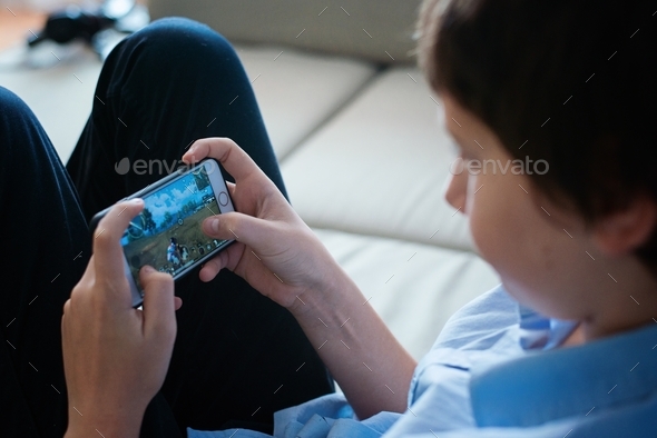 Boy playing game on mobile phone, children use technology Stock Photo ...