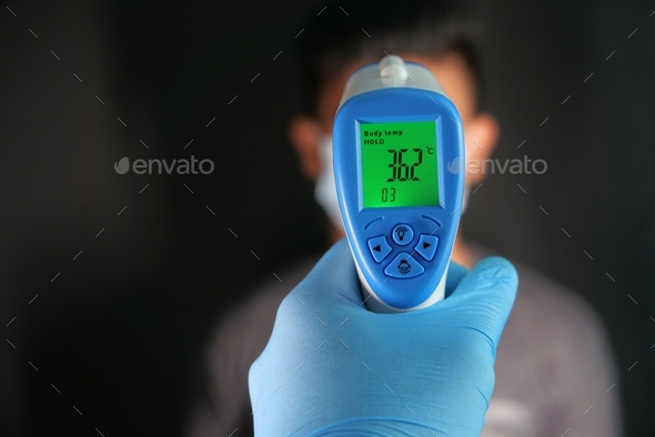 Hand holding infrared thermometer to measuring temperature. Stock Photo ...