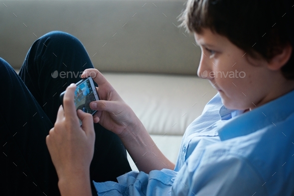 Boy playing game on mobile phone, children use technology Stock Photo ...