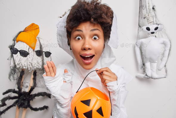 Surprised scared fearful woman holds carved pumpkin cannot believe her ...