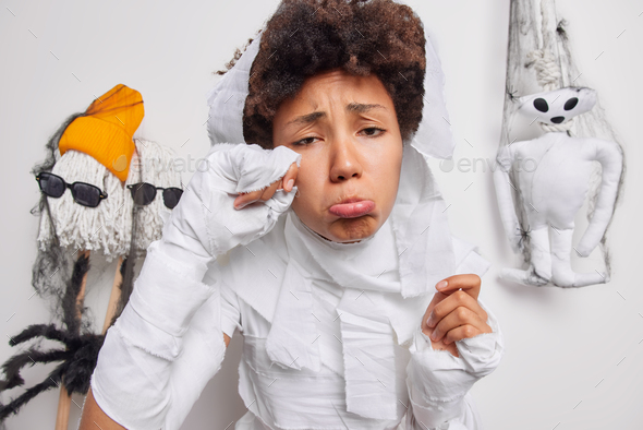 Upset crying young woman wipes tears feels unhappy purses lower lip ...