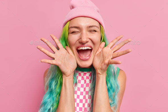 Photo of overjoyed woman keeps palms sideways near face laughs out ...