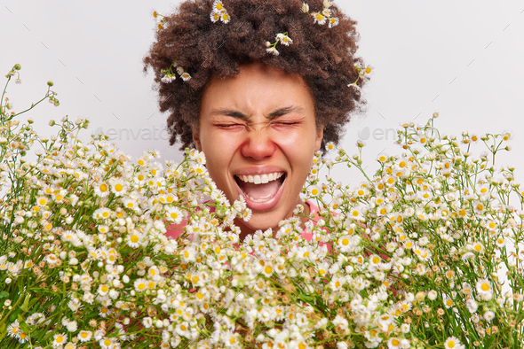 Emotional allergic young woman yells loudly keeps mouth opened eyes ...