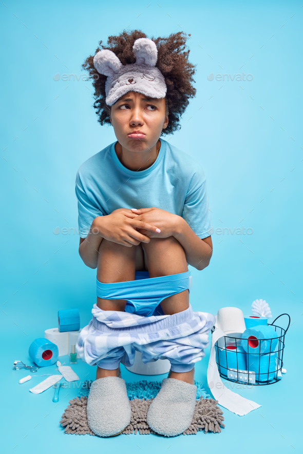 Displeased Afro American woman has dissatisfied expression suffers from ...