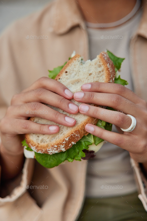 Faceless woman holds delicious sandwich eats appetizing snack dressed ...