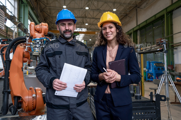 Female engineering manager and mechanic worker doing routine check up ...