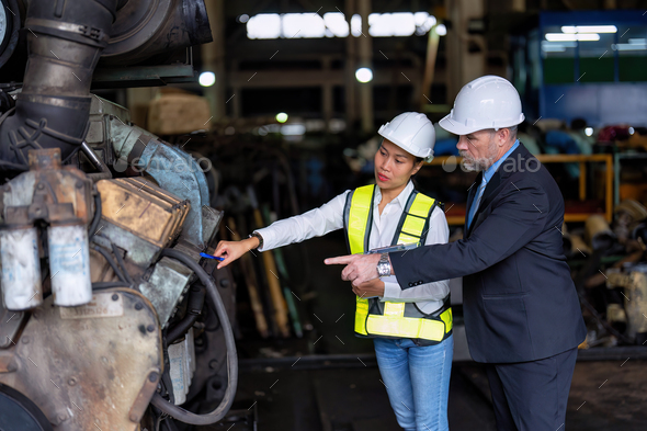 Maintenance manager and engineer checking part large engine ...