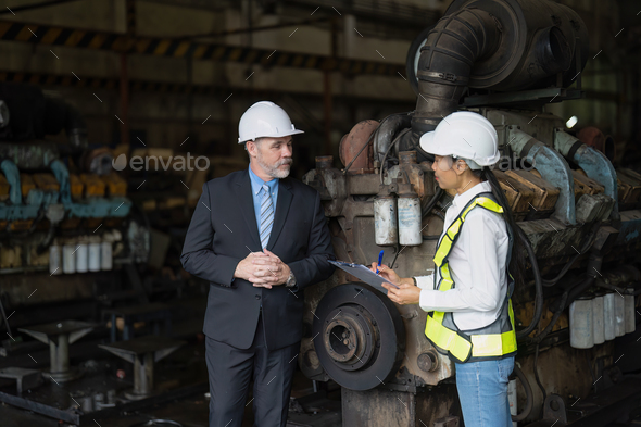 Maintenance manager and engineer checking part large engine ...