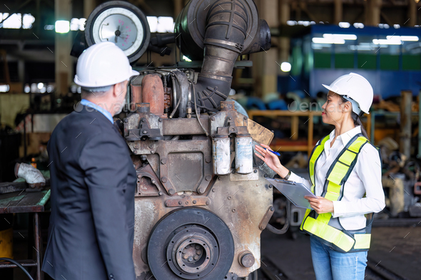 Maintenance manager and engineer checking part large engine ...