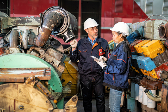 Maintenance manager and engineer checking part large engine ...