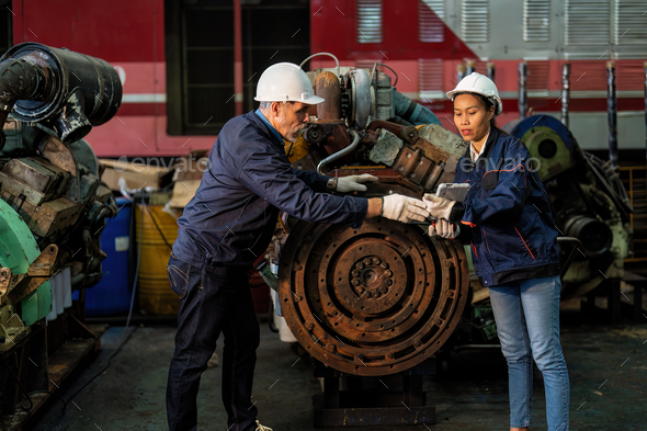 Maintenance manager and engineer checking part large engine ...